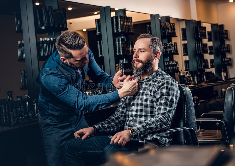Stylish Barber Grooming a Man`s Beard in a Saloon. Stock Image - Image ...