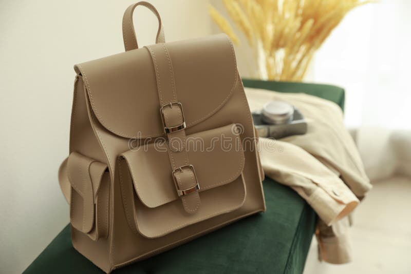 Stylish Beige Backpack and Jacket on Green Bench Indoors Stock Image ...