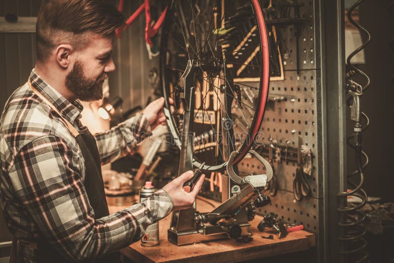 Stylish Bicycle Mechanic Doing His Professional Work in Workshop. Stock ...