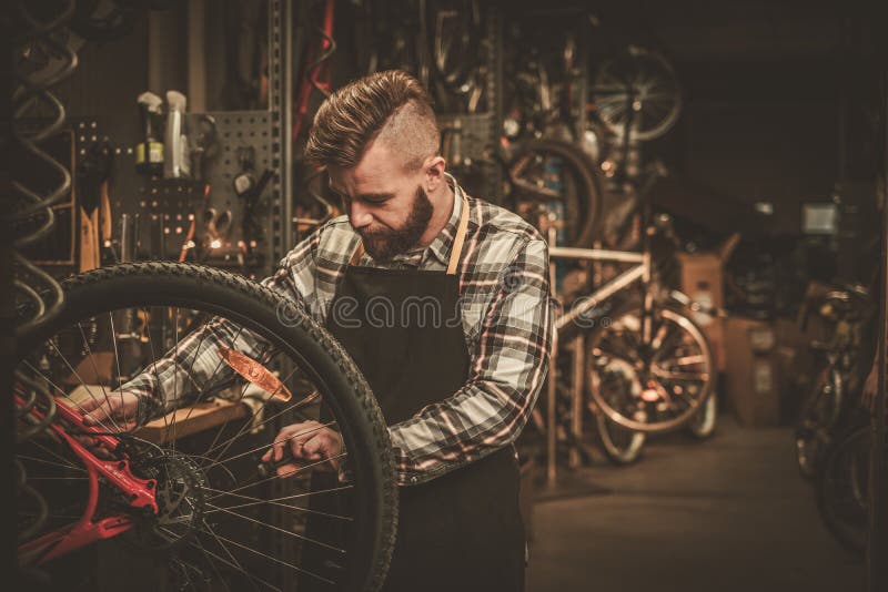 Stylish Bicycle Mechanic Doing His Professional Work in Workshop Stock ...