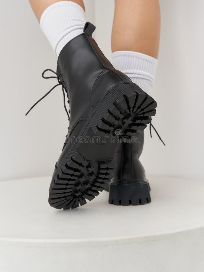 Stylish Black Boots with Unique Soles Captured in a Chic Studio Setting ...