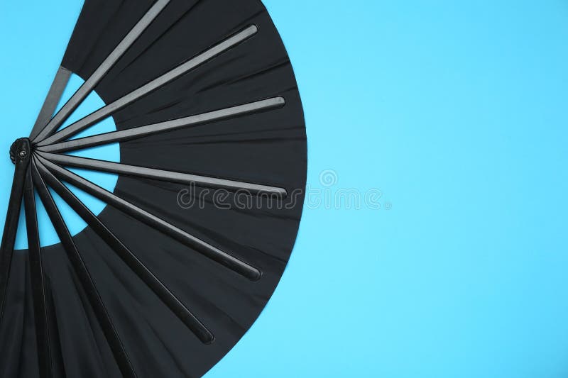 Stylish Black Hand Fan on Light Blue Background, Top View. Space for ...