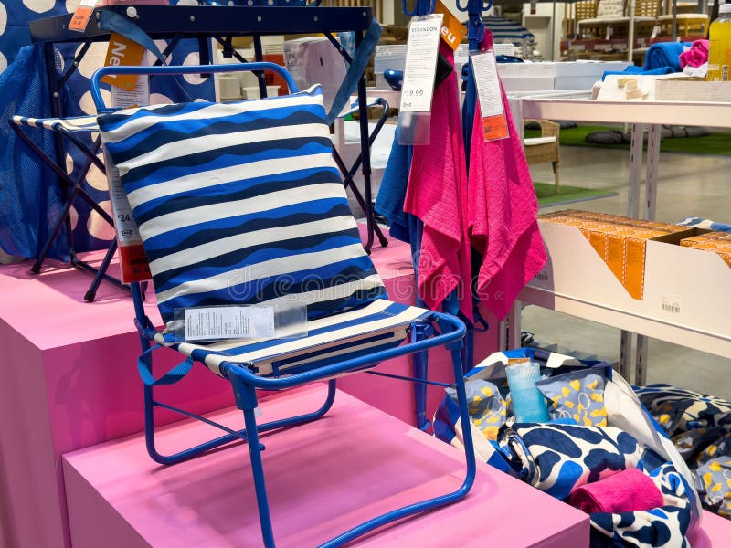 Stylish Blue Beach Chair with Striped Cushion in Store Display Setting ...