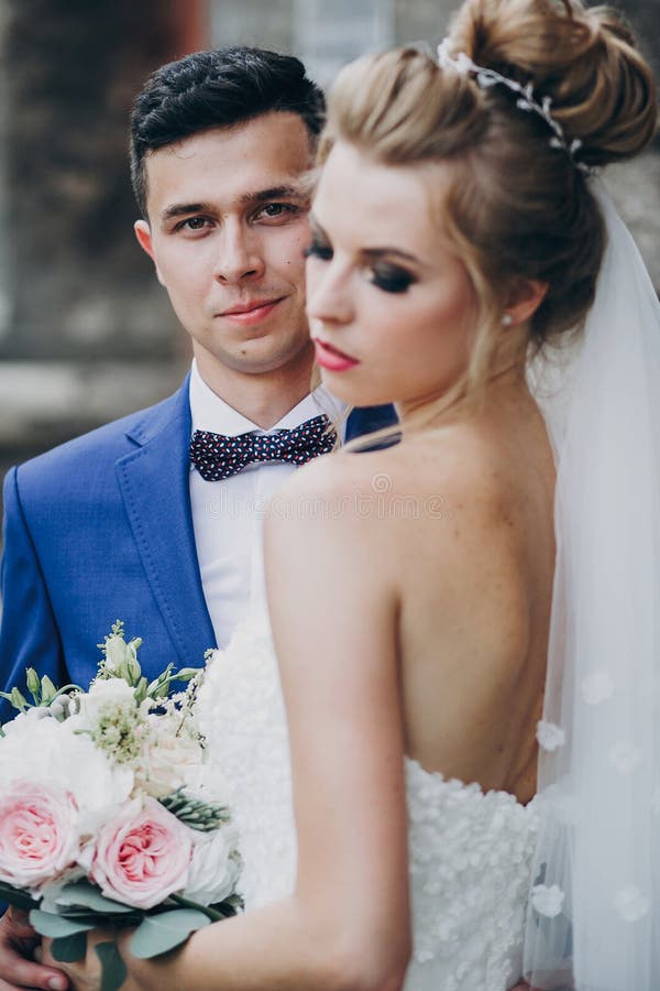 Stylish Bride And Groom Gently Hugging In Sunny European City Street