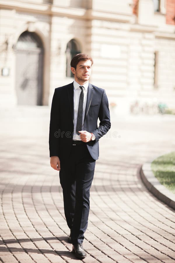 Stylish Businessman Walking Outdoors and Looking Away Stock Photo ...