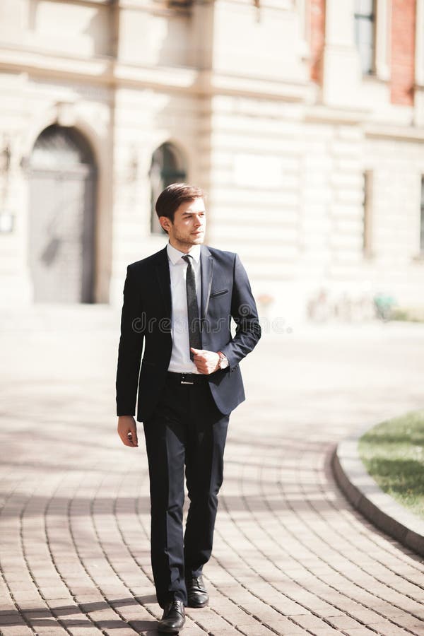 Stylish Businessman Walking Outdoors and Looking Away Stock Photo ...