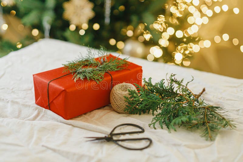 Stylish Christmas Gift and Green Branches on Rustic Table on Background ...