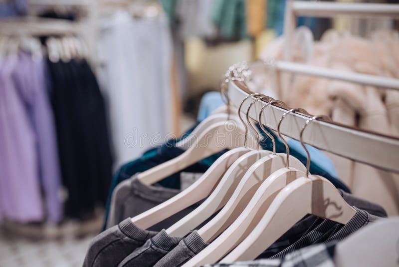 Stylish Clothes on a Hanger in a Store. New Collection of Coats. Stock ...