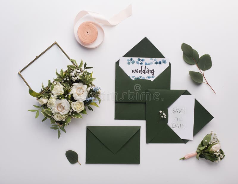 Stylish Dark Green Envelopes with Accessories on White Stock Photo ...