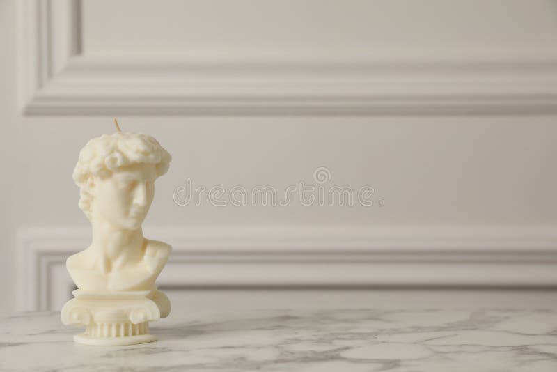 Stylish David Bust Candle on White Marble Table. Space for Text Stock ...