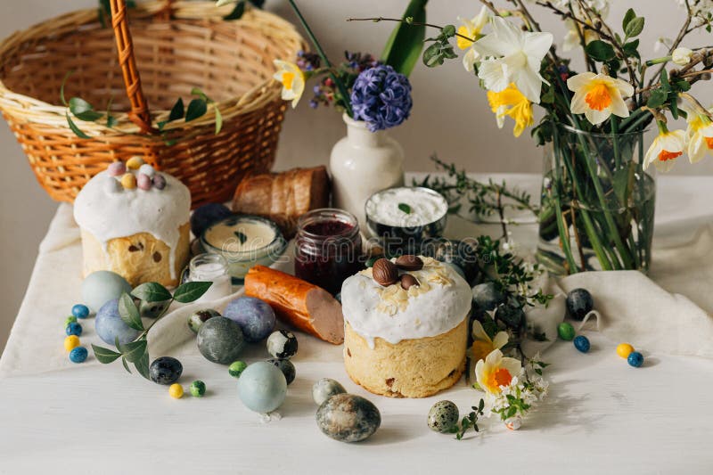 Stylish Easter Eggs, Bread and Basket with Spring Flowers on Rustic ...