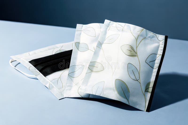 Stylish Eco-friendly Face Masks with Leaf Patterns on Blue Background ...