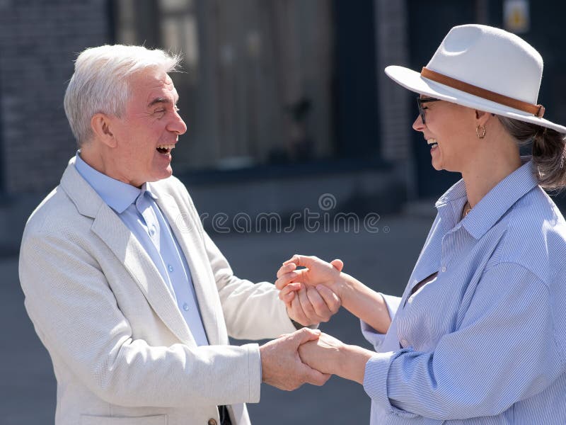 Stylish Elderly Laughing Couple on a Walk. Romantic Relationships of ... Stylish Elderly Laughing Couple on a Walk. Romantic Relationships of ...