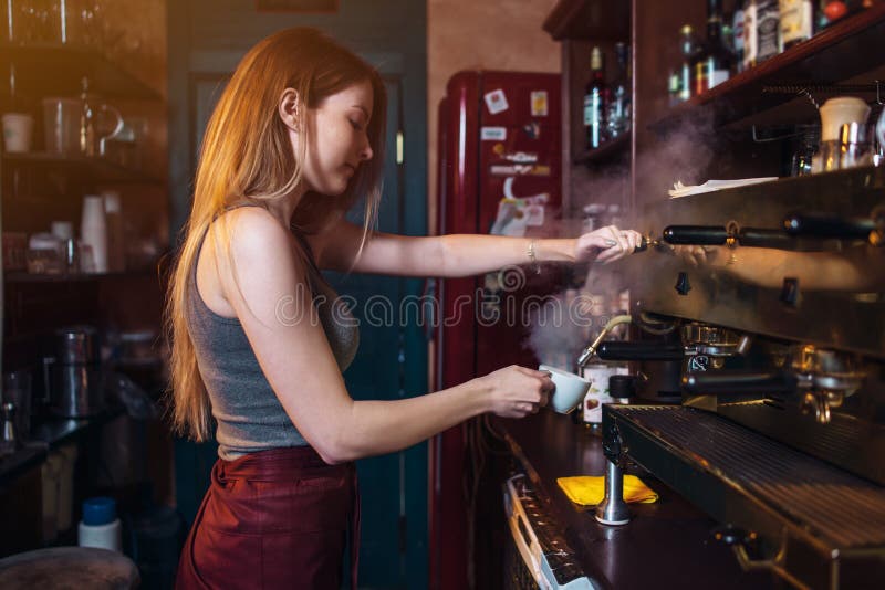 Stylish Ginger Girl Making Coffee Using a Professional Coffee Machine ...