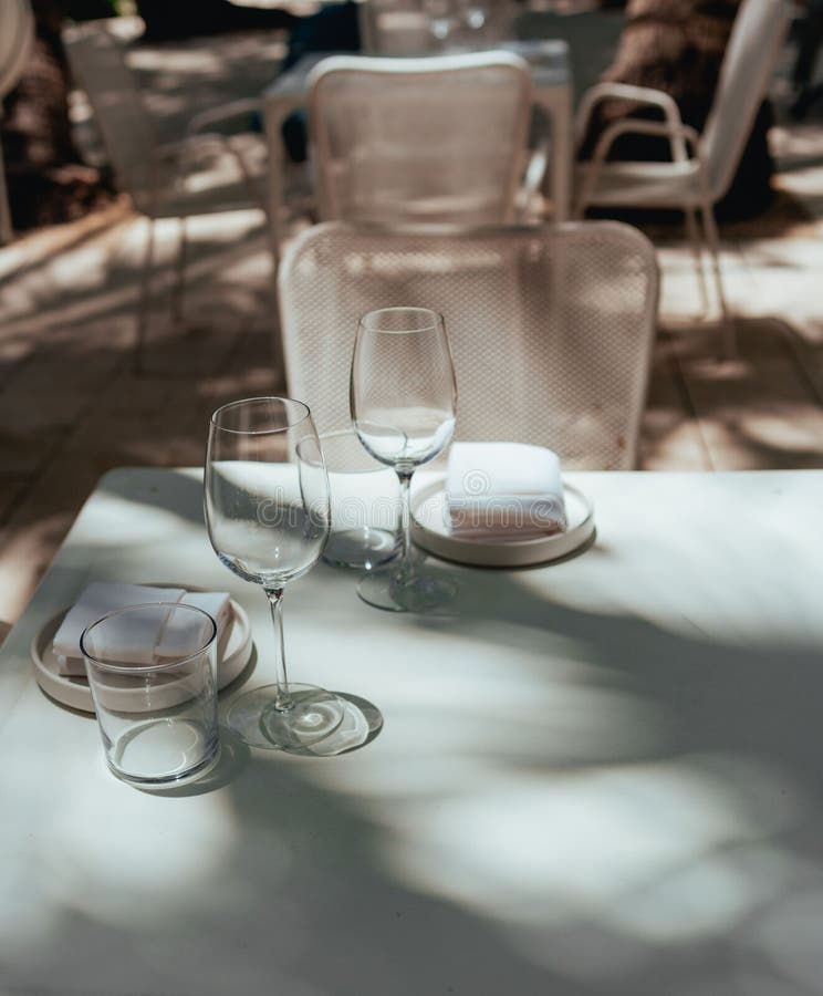 Stylish Glassware on an Outdoor Cafe Table, Vertical Stock Image ...