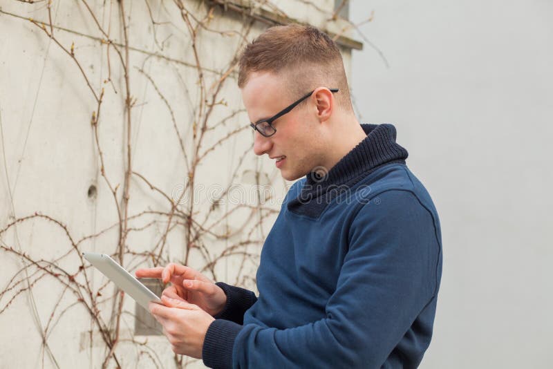 Stylish Guy Connected on Internet with Tablet in Town. he is Hap Stock ...