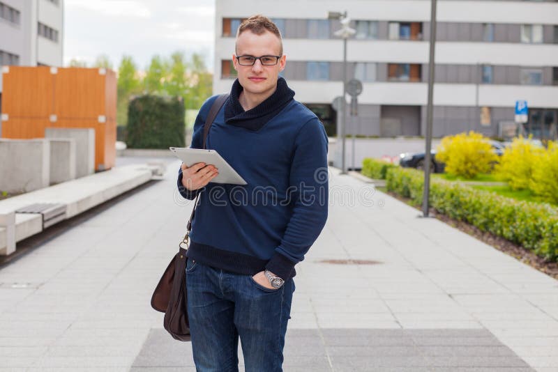 Stylish Guy Connected on Internet with Tablet in Town. he is Hap Stock ...
