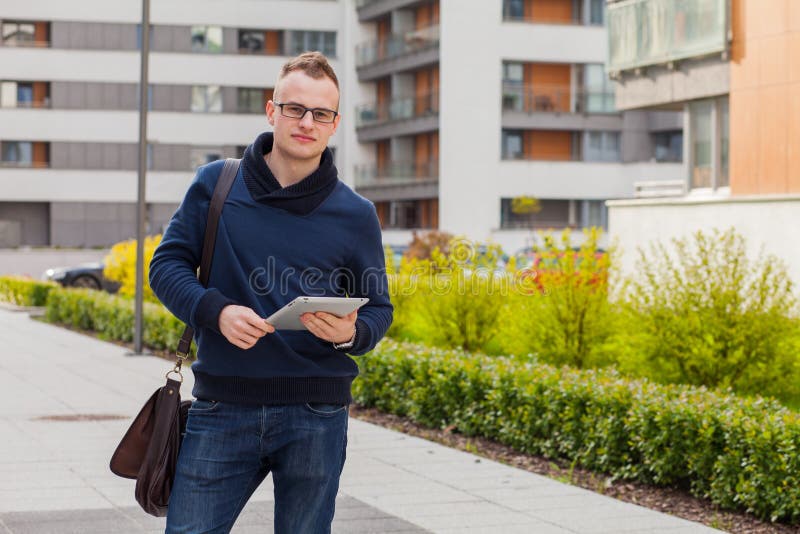 Stylish Guy Connected on Internet with Tablet in Town. he is Hap Stock ...