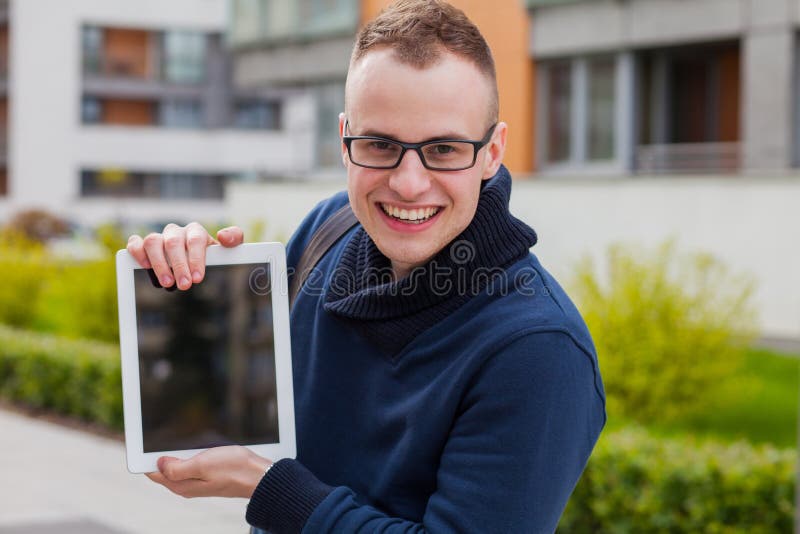 Stylish Guy Connected on Internet with Tablet in Town. he is Hap Stock ...
