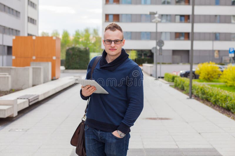 Stylish Guy Connected on Internet with Tablet in Town. he is Hap Stock ...