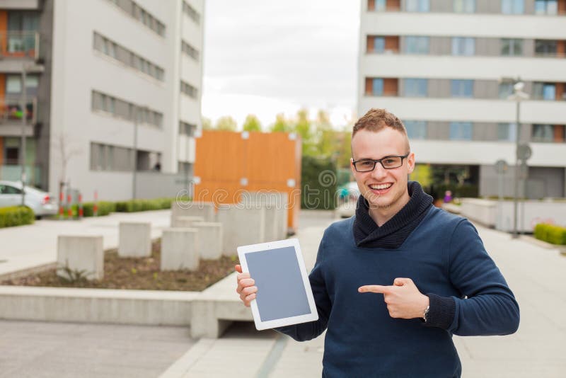 Stylish Guy Connected on Internet with Tablet in Town. he is Hap Stock ...