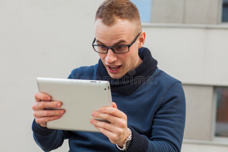 Stylish Guy Connected on Internet with Tablet in Town. he is Surprised ...