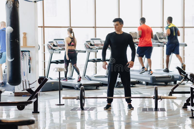 A Stylish Guy in the Gym Pulls the Barbell. Healthy Lifestyle Stock ...