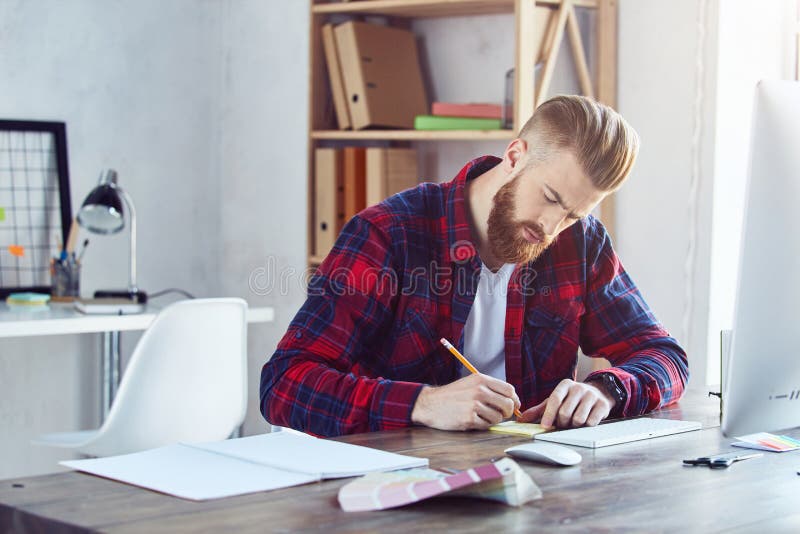 Stylish Guy Working at His Workplace while Writing Notes on Paper Stock ...