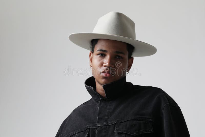 Stylish And Handsome Dark Skinned Man Wearing Trendy Hat Looking At The