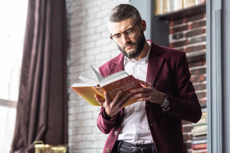 Stylish Handsome Man Standing Near Window while Reading Book Stock ...