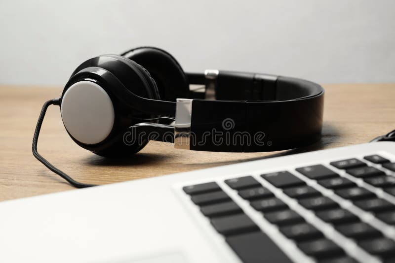 Stylish Headphones and Laptop on Table. Stock Image - Image of computer ...