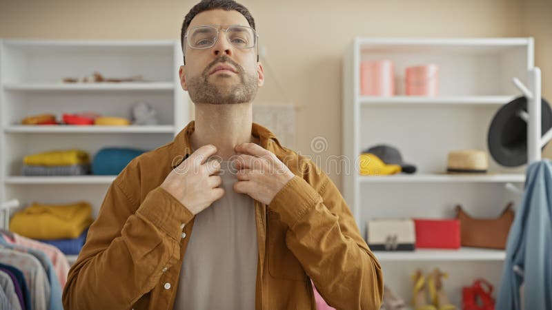 A Stylish Hispanic Man Adjusts His Brown Jacket in a Bright Modern ...