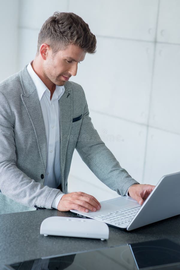 Stylish Man Sitting Typing on a Laptop Stock Photo - Image of caucasian ...
