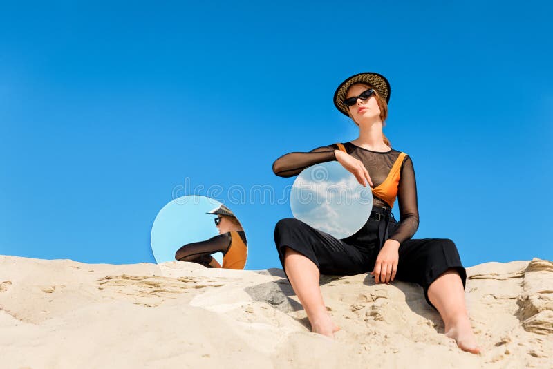 Stylish Model Posing with Round Mirrors with Reflection of Stock Image ...