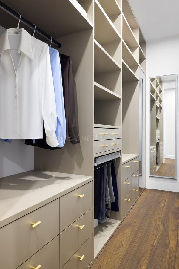 A Stylish and Modern Closet that Features Organized Storage Solutions ...