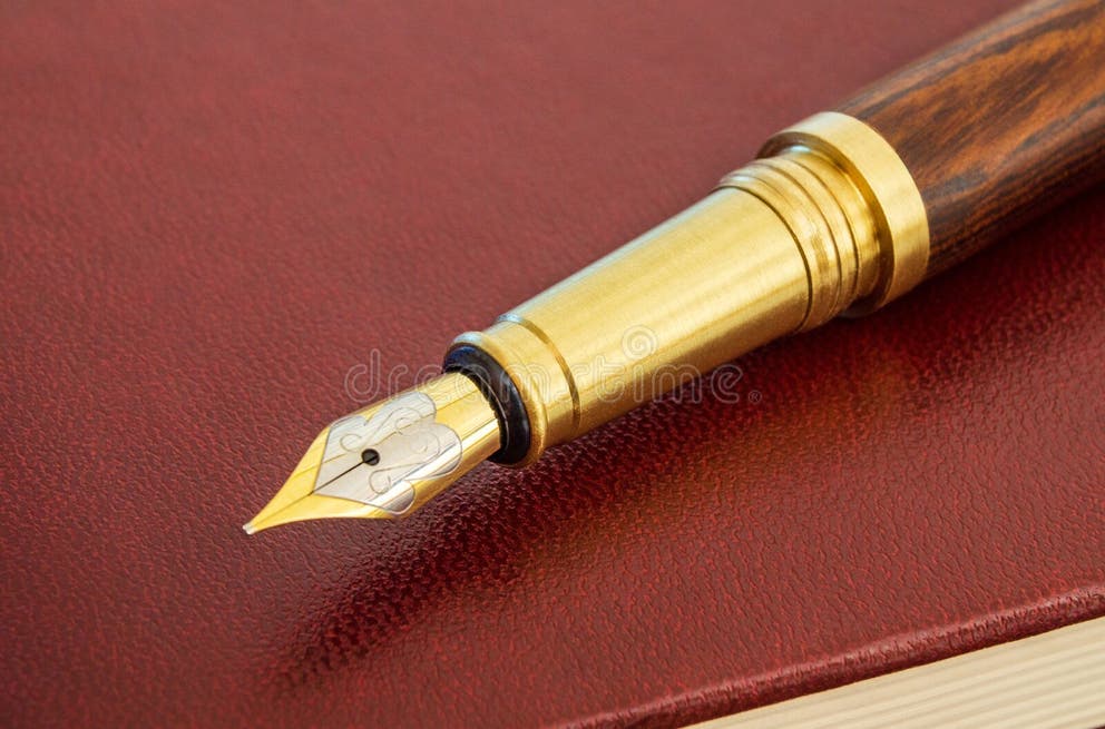 Stylish Pen with a Gold Plated Pen on Brown Notepad for Notes Close Up ...