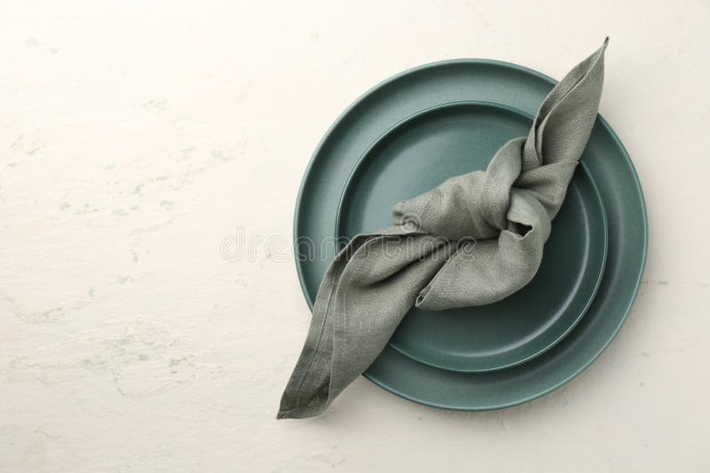 Stylish Plates and Napkin on Beige Textured Table, Top View. Space for ...