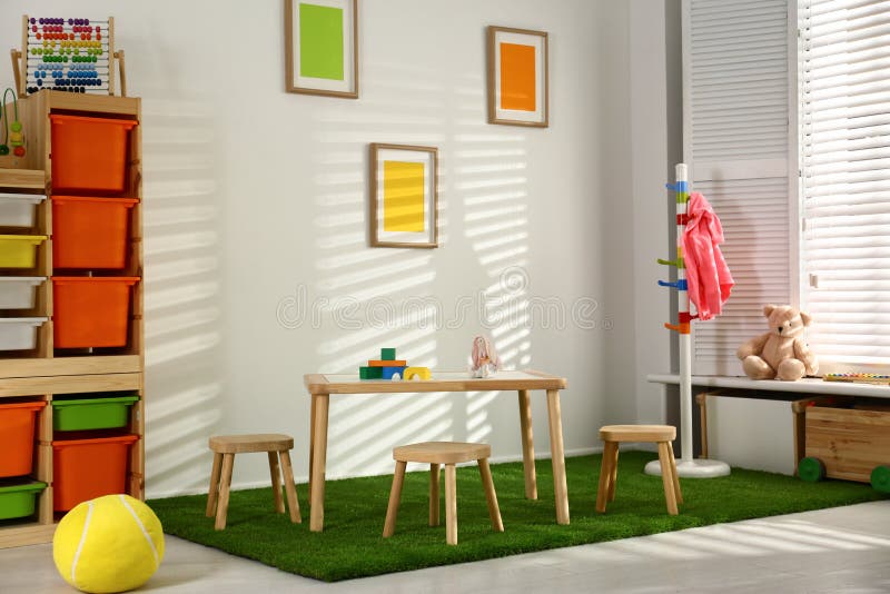 Stylish Playroom Interior with Table and Stools Stock Photo - Image of ...