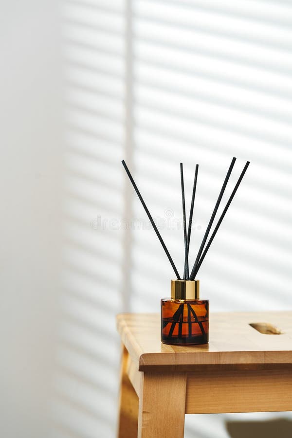 Elegant Reed Diffusers on Wooden Surface with Soft Background Light ...