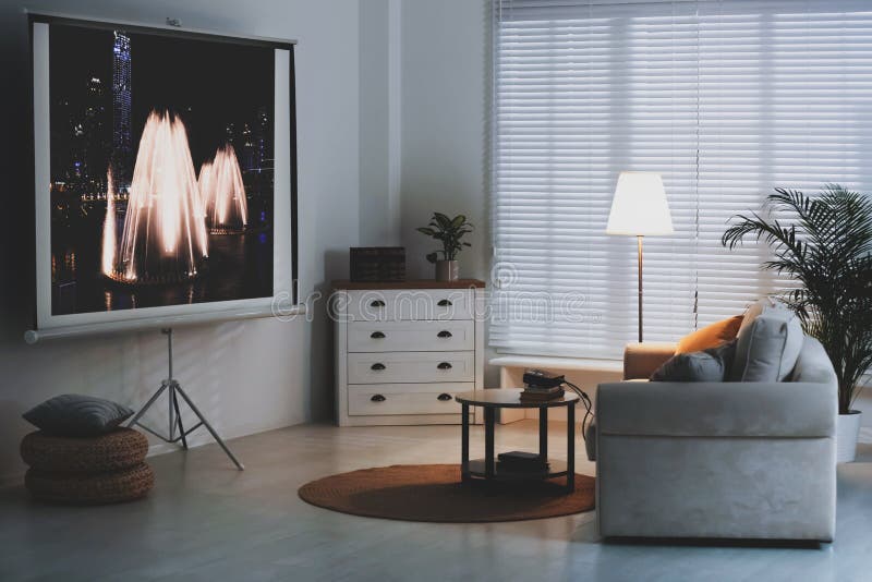 Stylish Room with Video Projector and Comfortable Sofa Stock Photo ...
