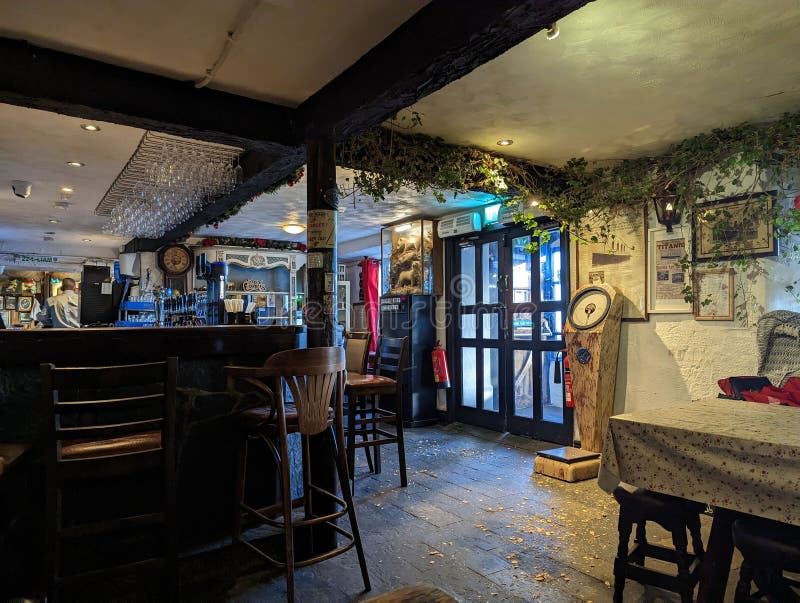 An Empty Bar with Wooden Tables, Stools and a Clock Editorial ...