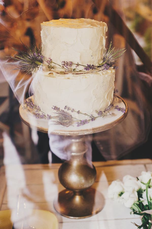 Stylish Rustic Wedding Cake with Lavender and Thistle Decor on Vintage ...