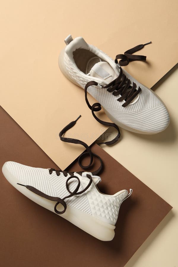 Stylish Sneakers with Brown Shoe Laces on Color Background, Flat Lay ...