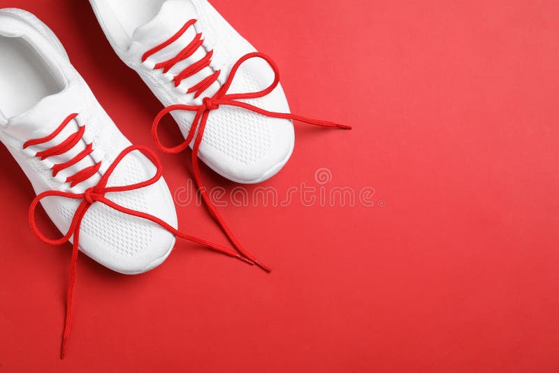 Stylish Sneakers with Shoe Laces on Red Background, Flat Lay. Space for ...