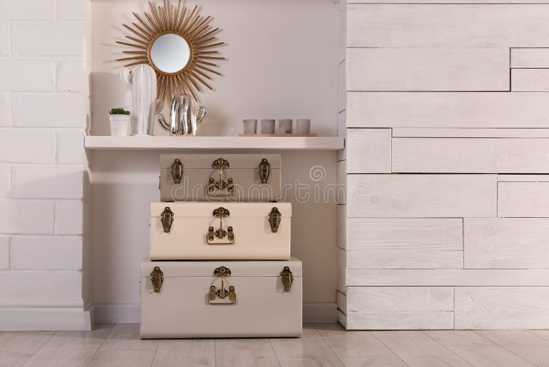 Stylish Storage Trunks and Different Decor Elements Near White Wall ...