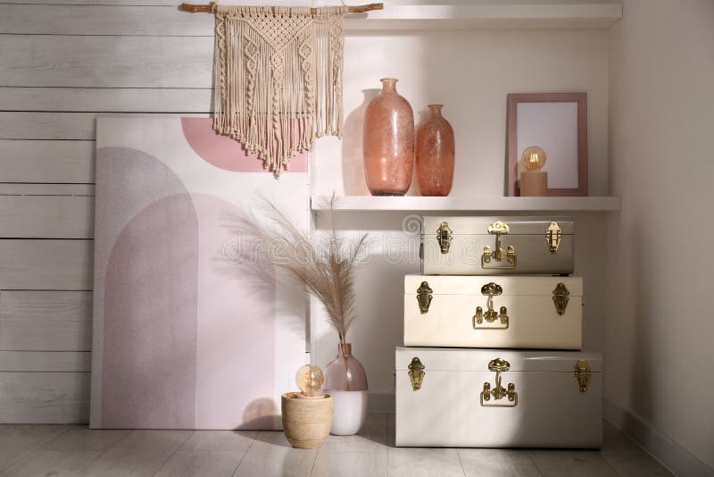 Stylish Storage Trunks and Different Decor Elements Near White Wall ...