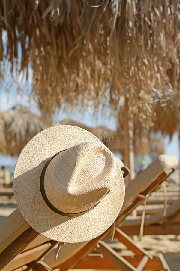 Stylish Straw Hat on Sunbed at Beach Stock Photo - Image of stylish ...