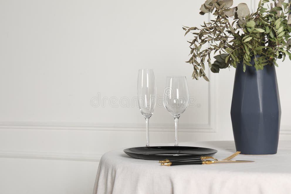 Stylish Table Setting with Black Dishware in Dining Room, Space for ...