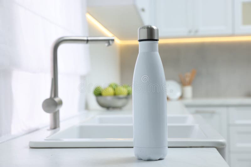 Stylish Thermo Bottle on White Countertop in Kitchen. Space for Text ...