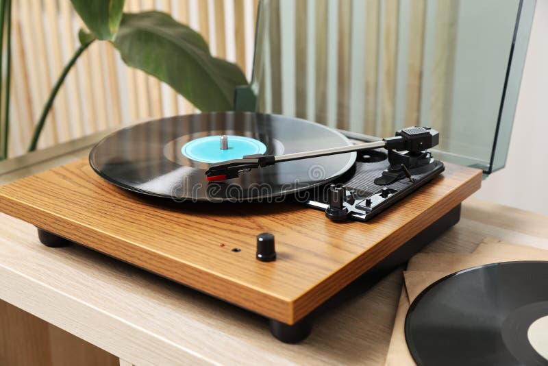 Stylish Turntable with Vinyl Disc on Light Wooden Table Indoors Stock ...